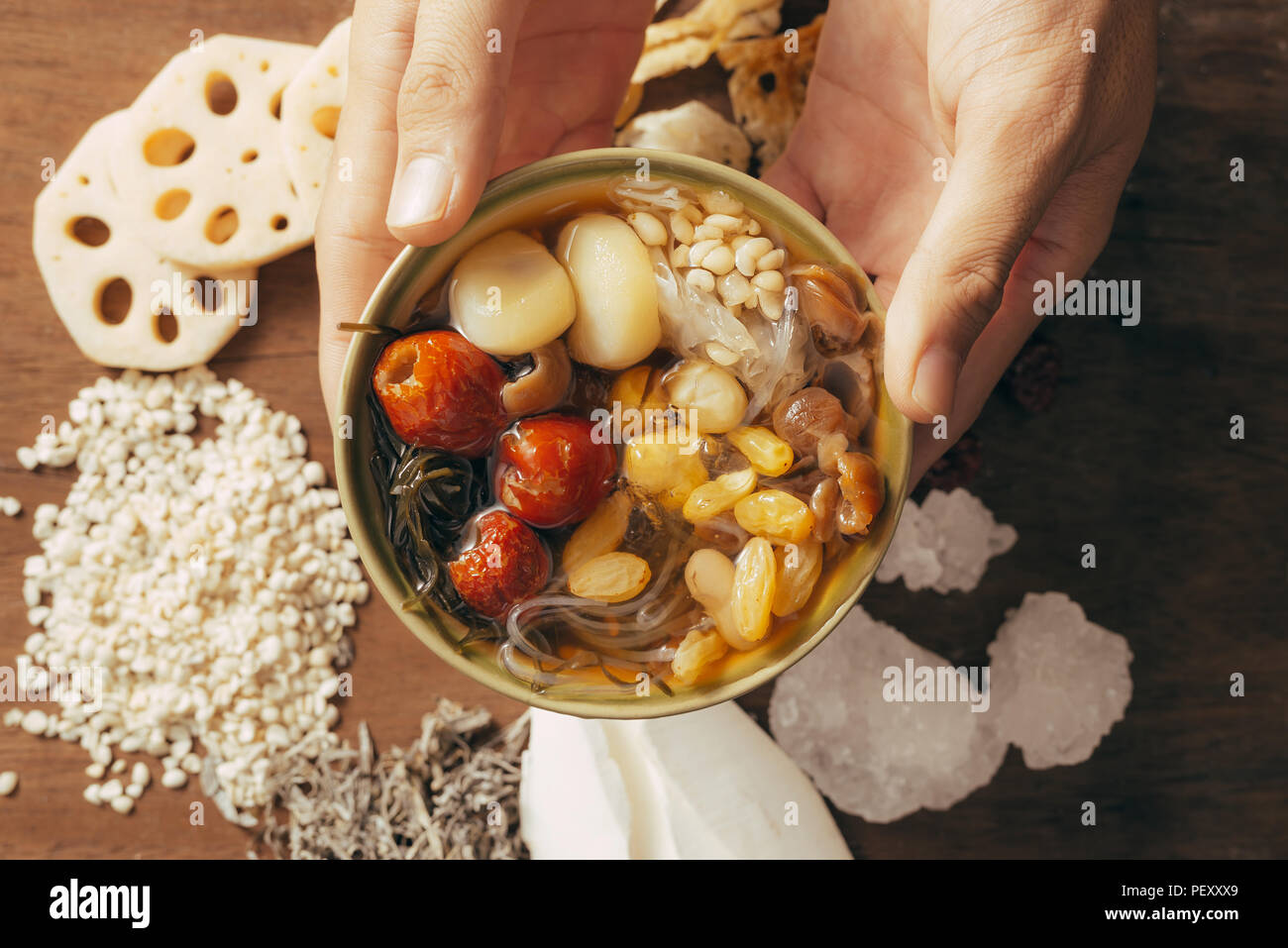 Hand holding with Ching bo leung in bowl Stock Photo - Alamy