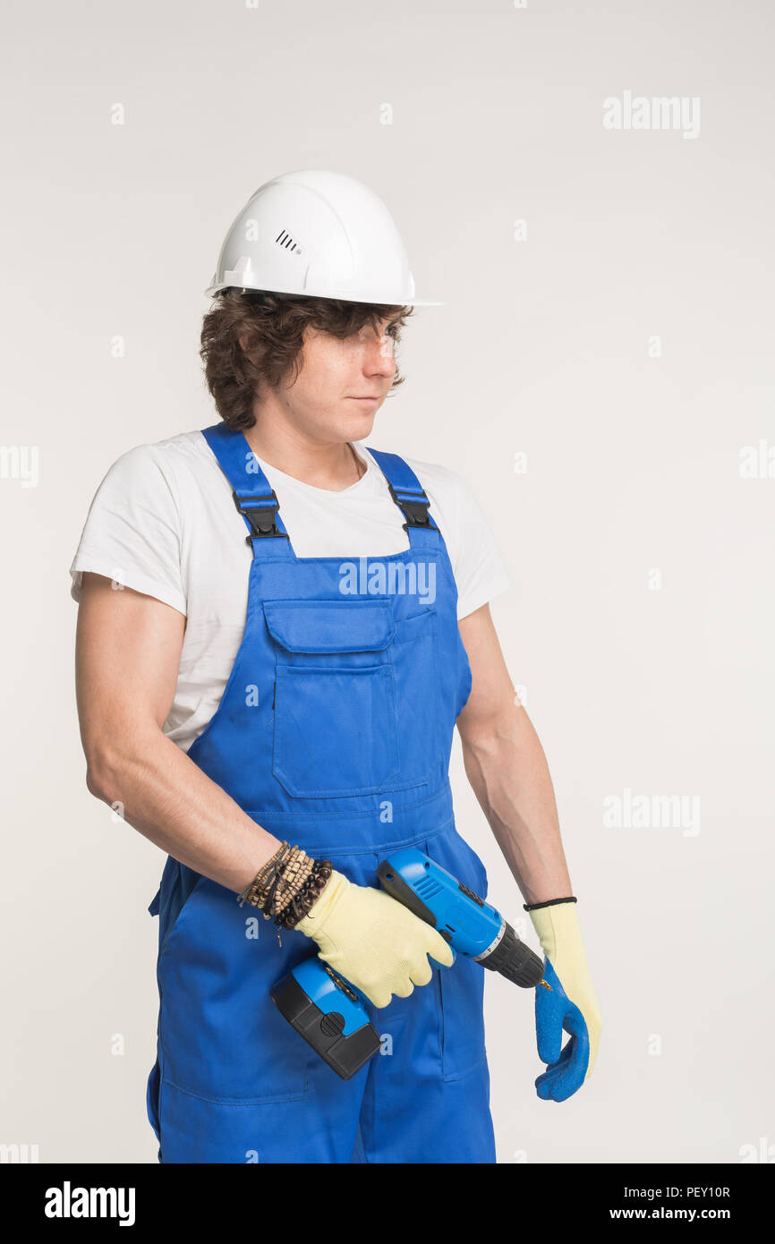 Portrait of handsome builder with skrewdriver on white background Stock ...