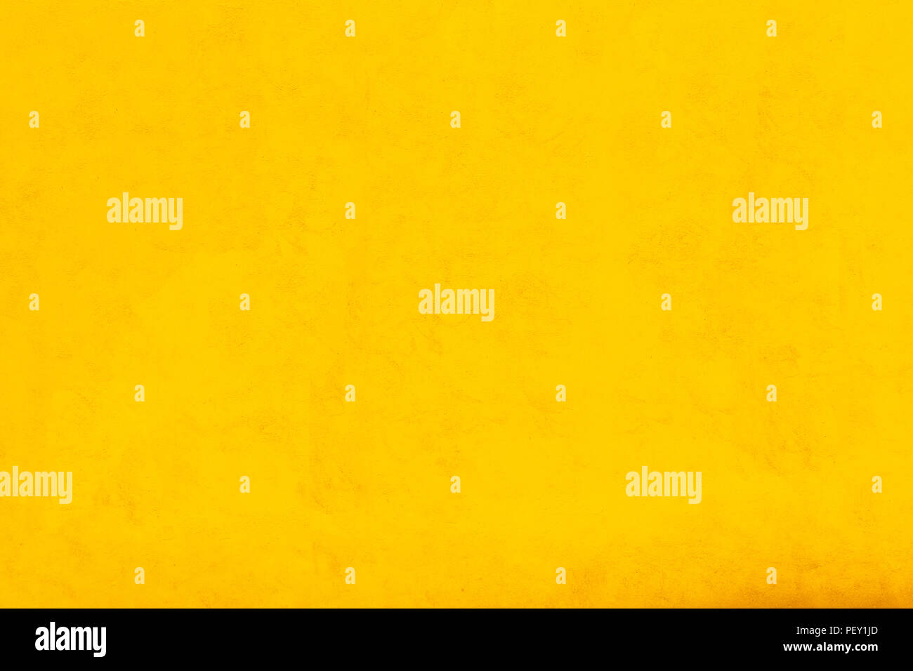 Yellow wall from a house coarse exterior facade with intense vivid ...