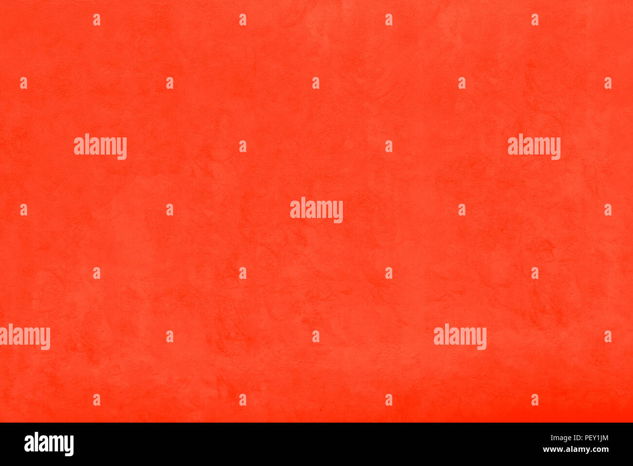 Red wall from a house coarse exterior facade with intense vivid color ...