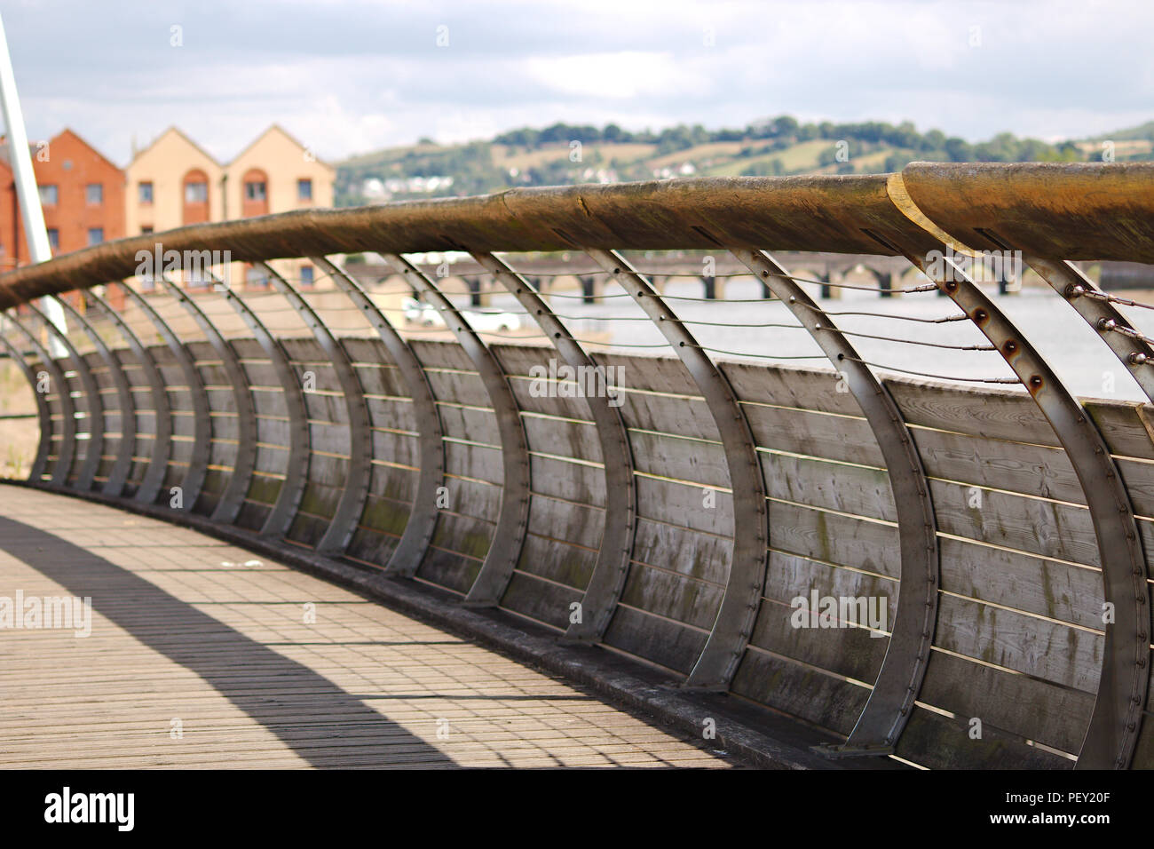 A contemporary wood and stainless steel construction of a foot bridge ...