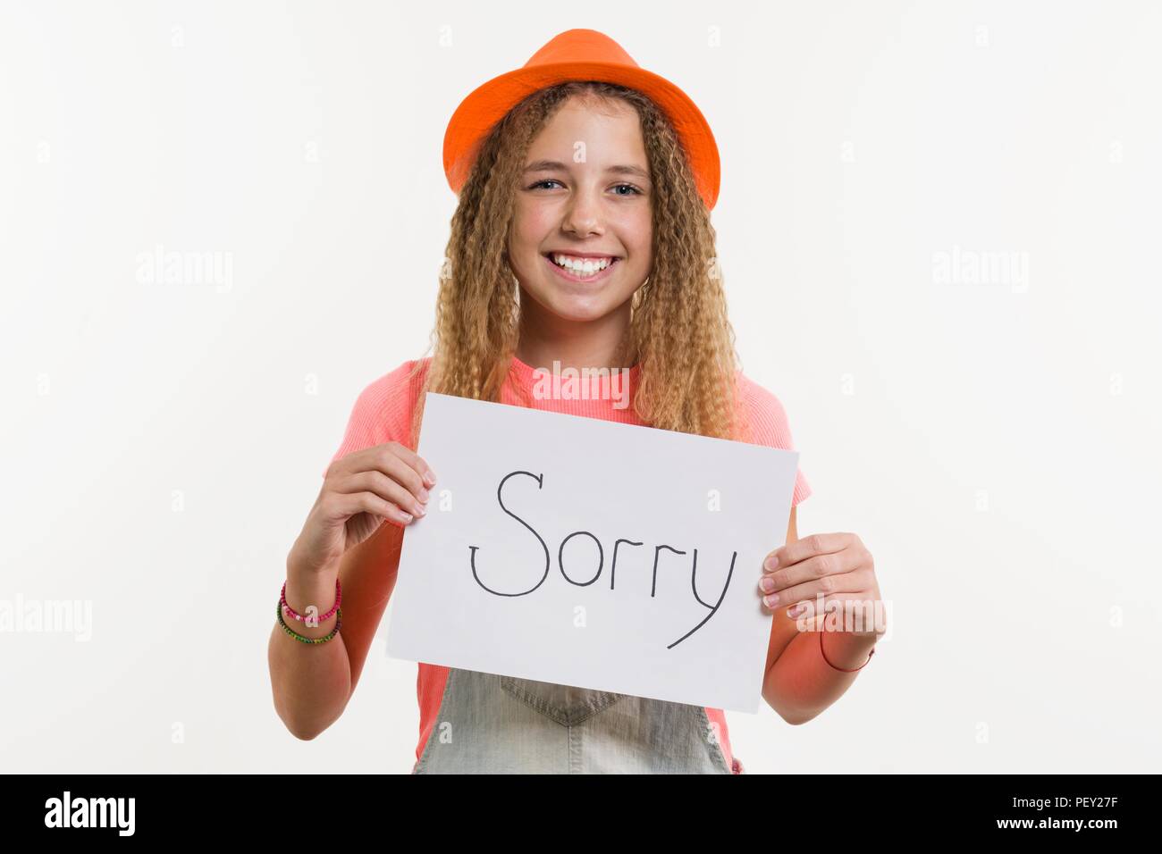 Cute teen girl character holding a sign with message sorry on white ...