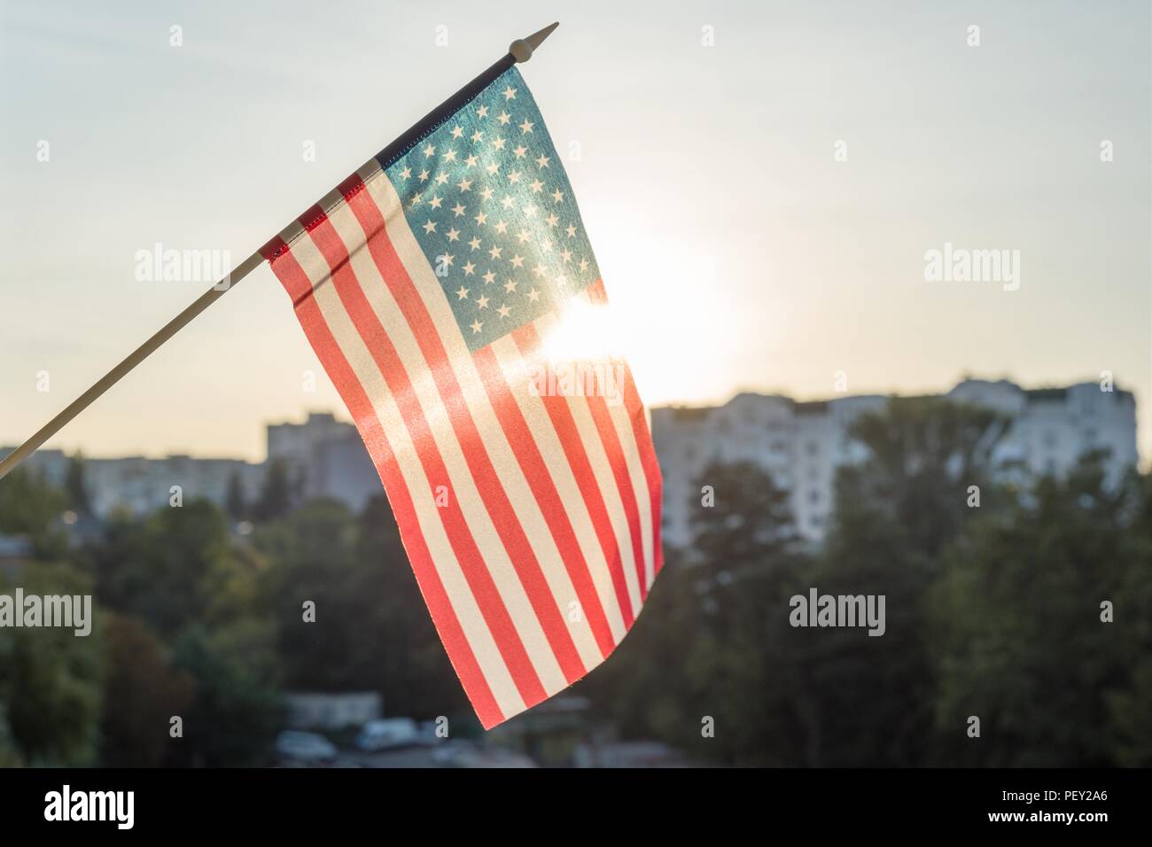 American flag from the window on sunset background Stock Photo - Alamy