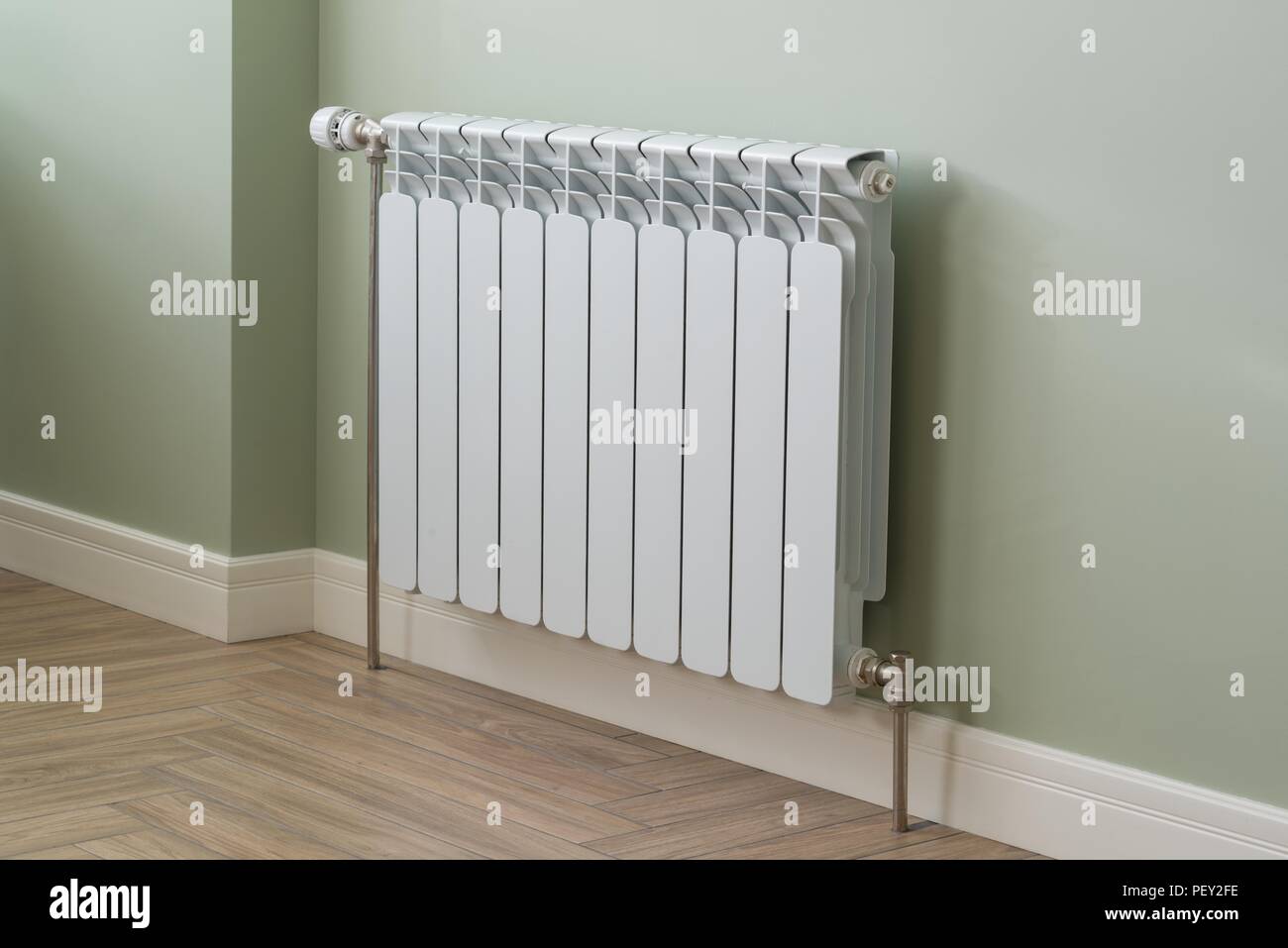 Heating Radiator, White radiator in an apartment Stock Photo - Alamy