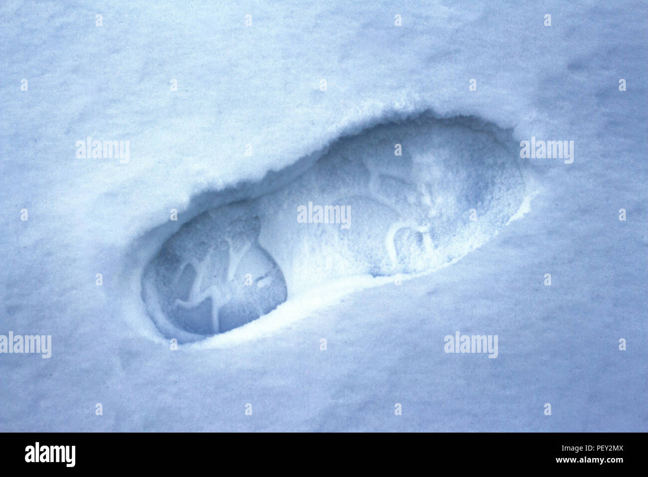 Foot step of winter boot in deep white blue snow Stock Photo - Alamy