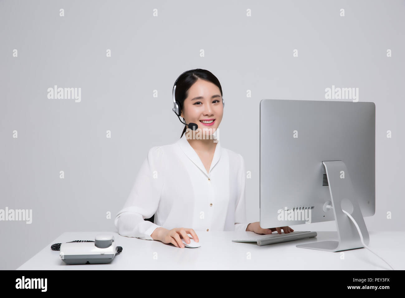 Customer support operators working in call center office, wearing ...