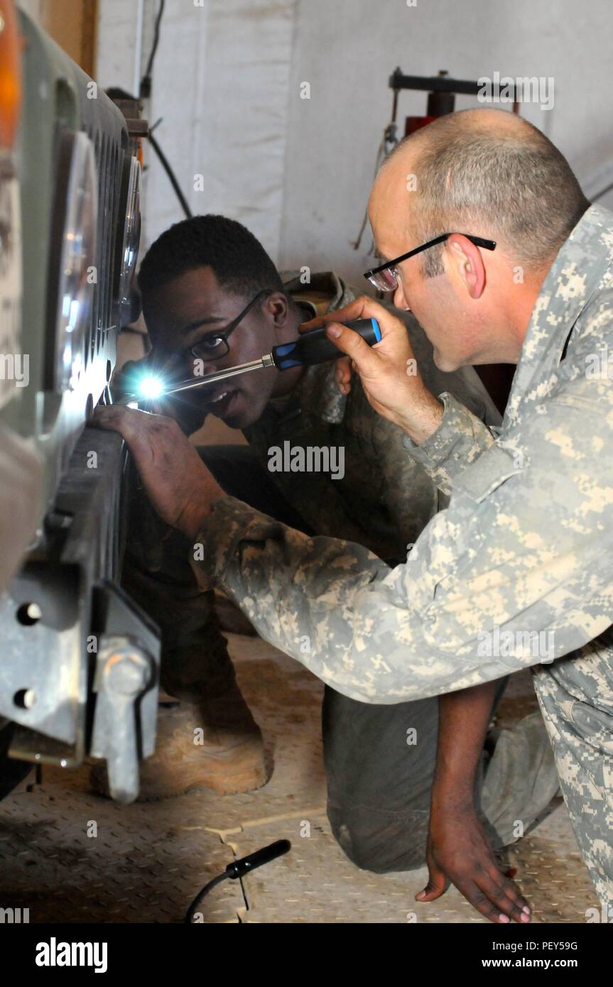 Sgt. Jesse Bankston (front), a wheeled vehicle mechanic for 103rd ...