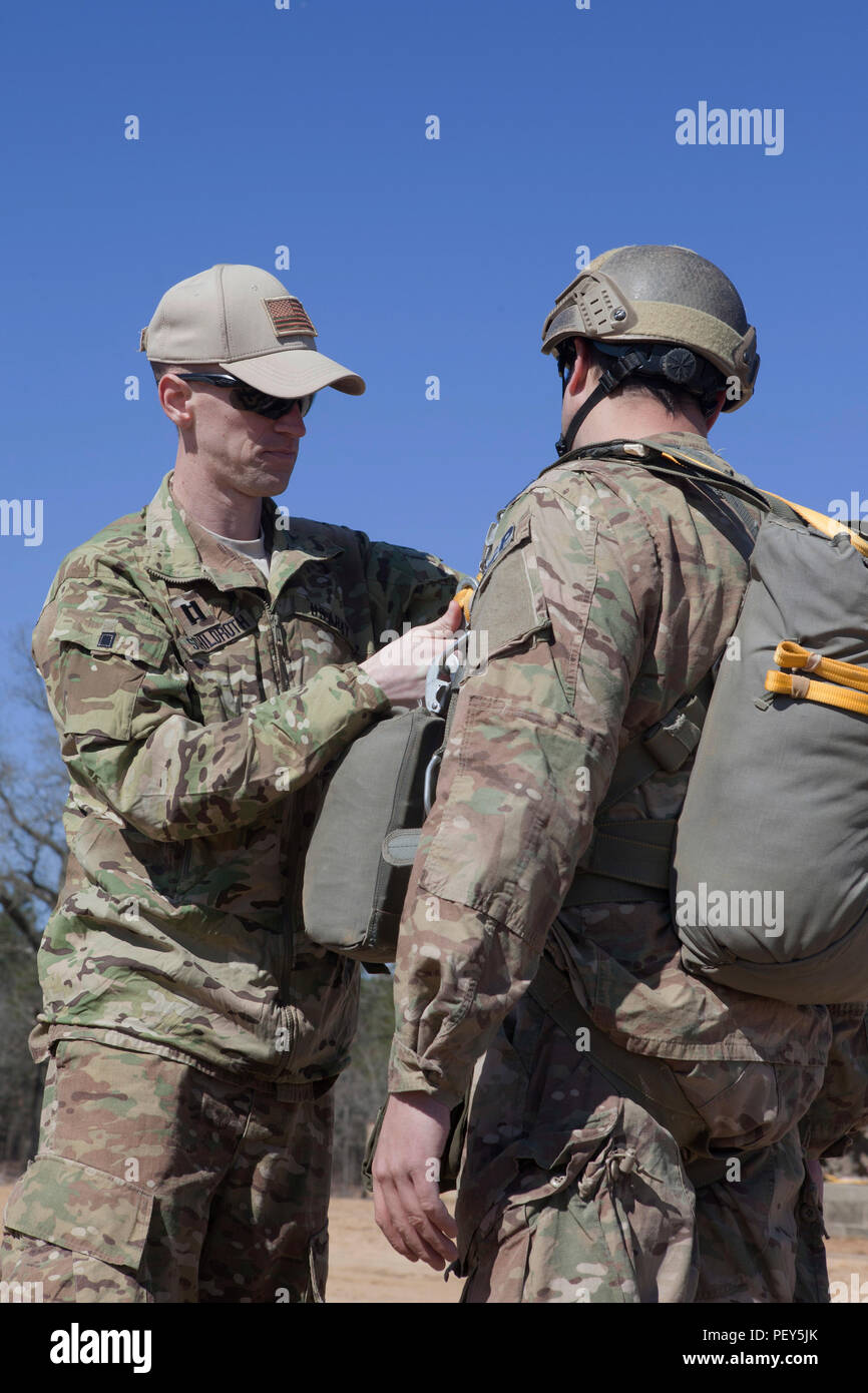 A U.S. Army jumpmaster checks the reserve parachute of a fellow soldier ...