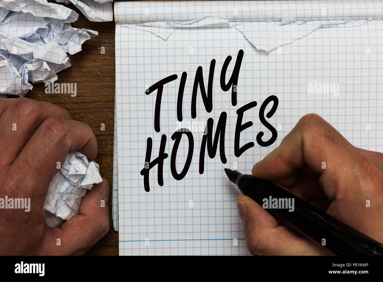 Text sign showing Tiny Homes. Conceptual photo houses contain one room ...