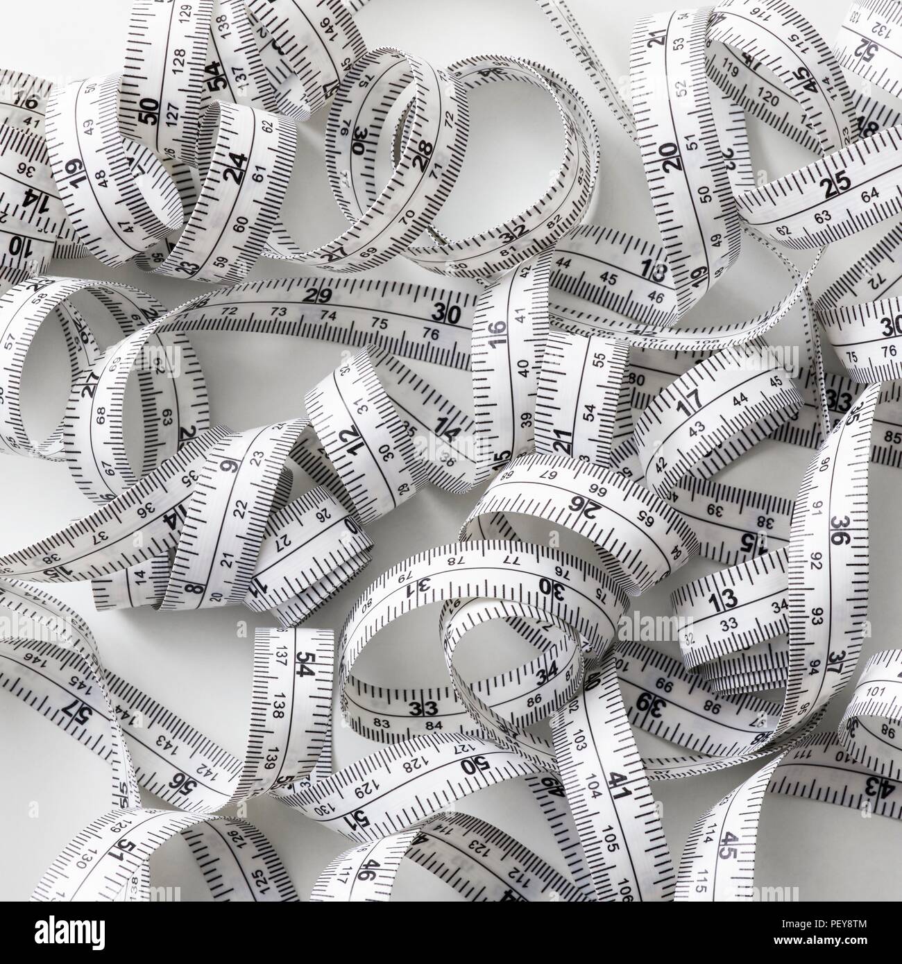 Measuring tape against a white background Stock Photo - Alamy