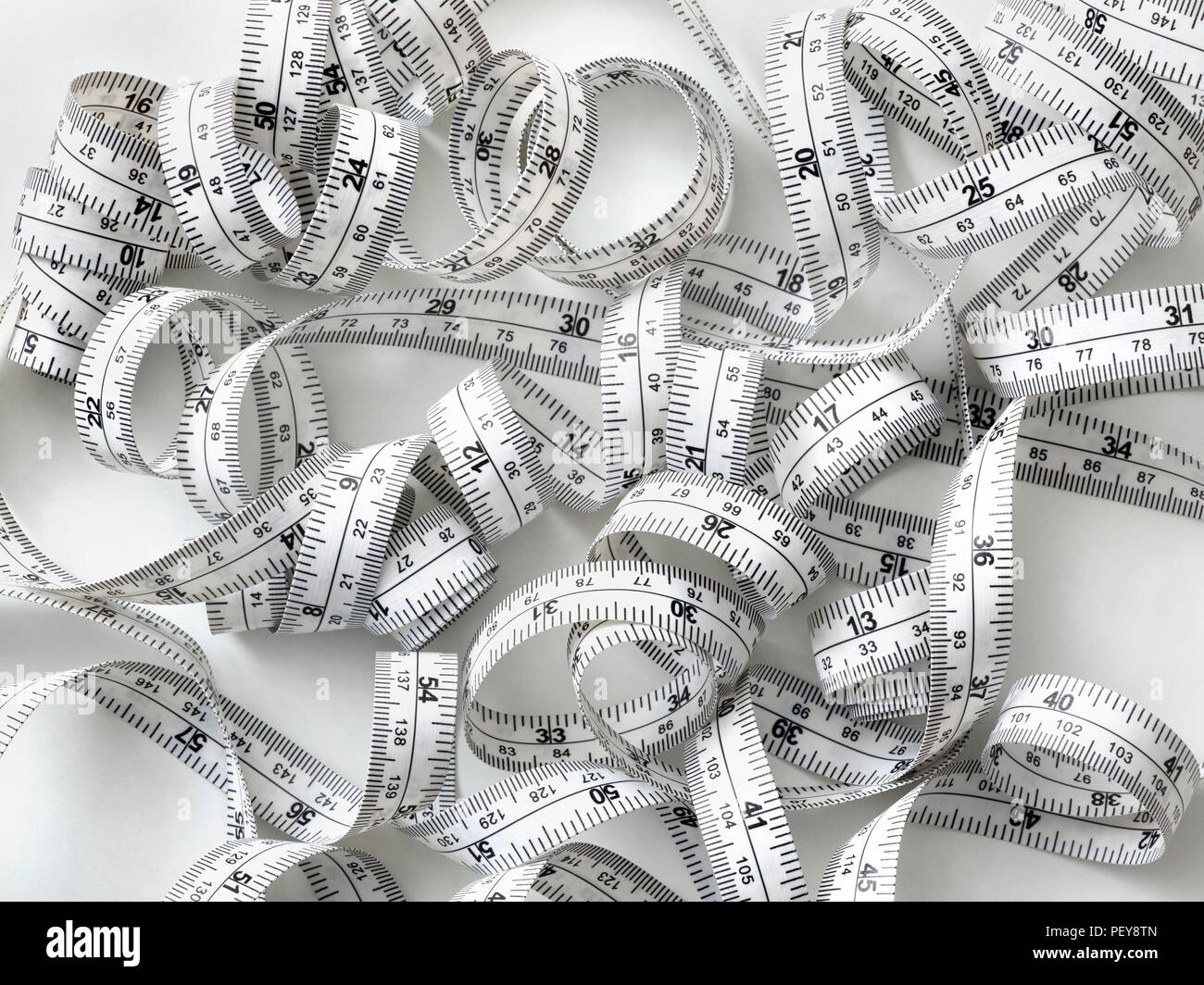 Measuring tape against a white background Stock Photo - Alamy