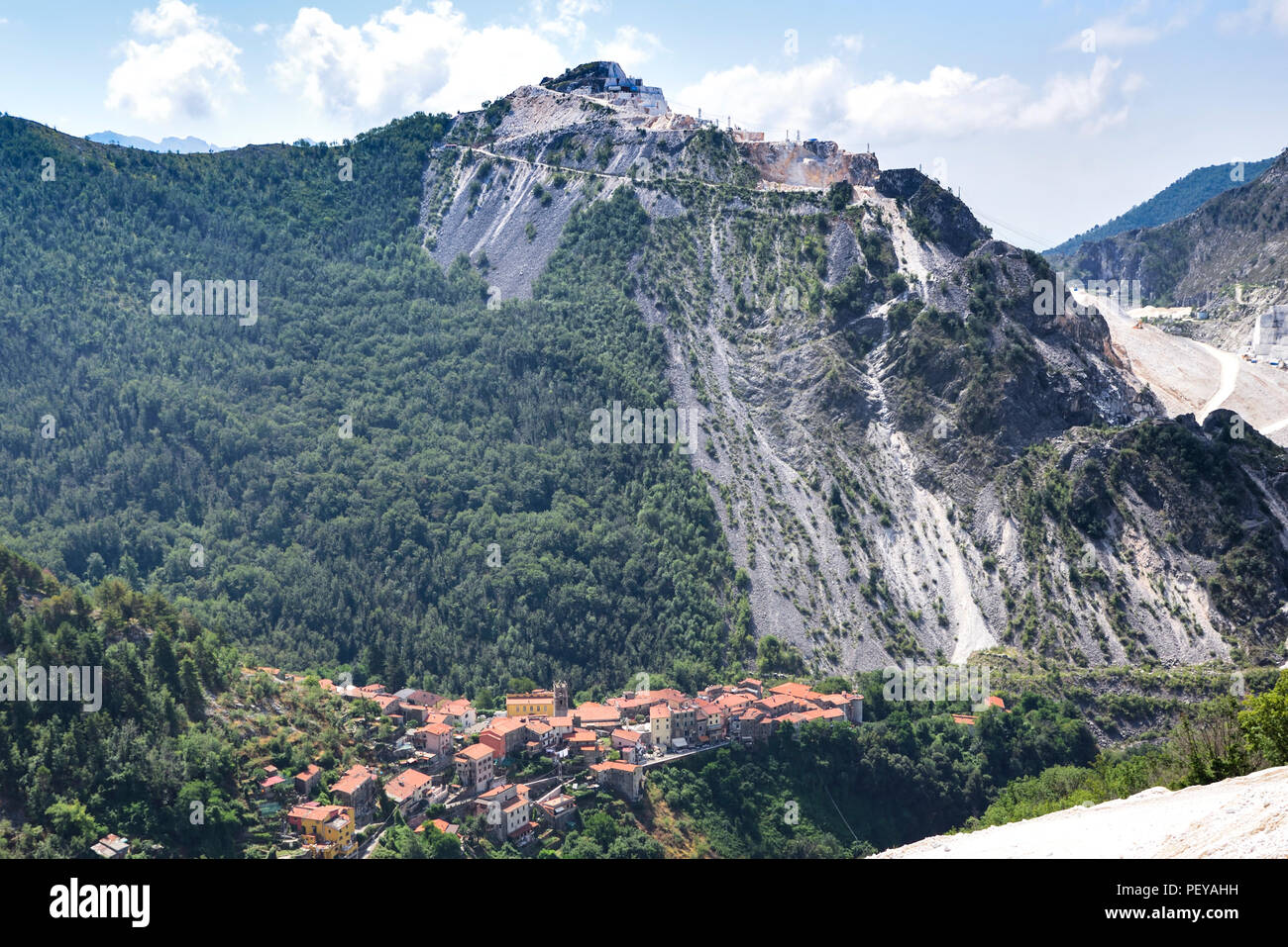 Precious Carrara marble. Quarry on the Apuan Alps and the town of ...
