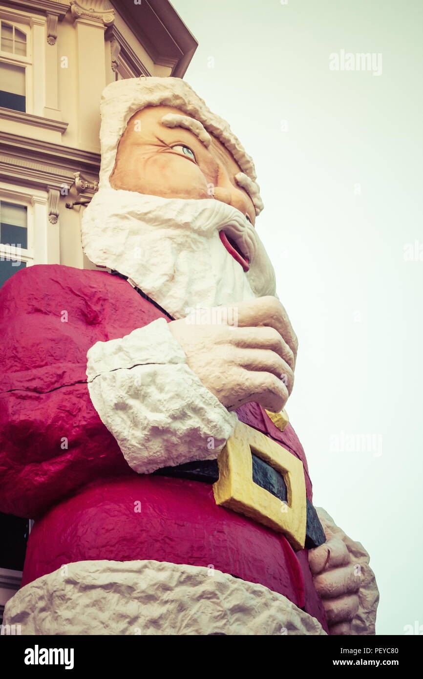 A Giant Santa Claus Christmas decoration on the side of a building in ...