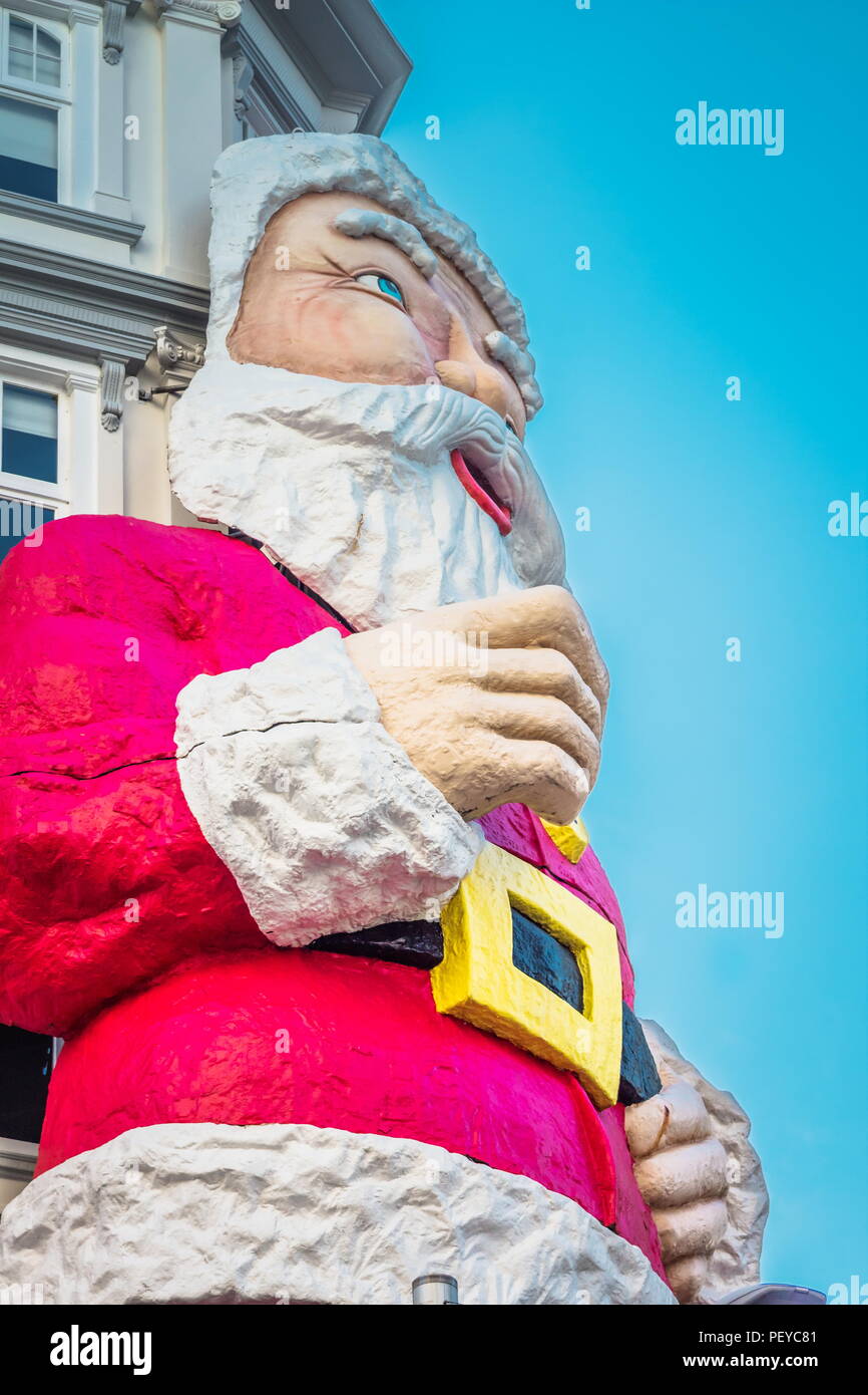 A Giant Santa Claus Christmas decoration on the side of a building in ...