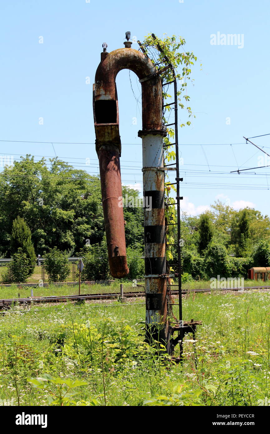 Rusted metal railway white and black water pump with rusted and ...