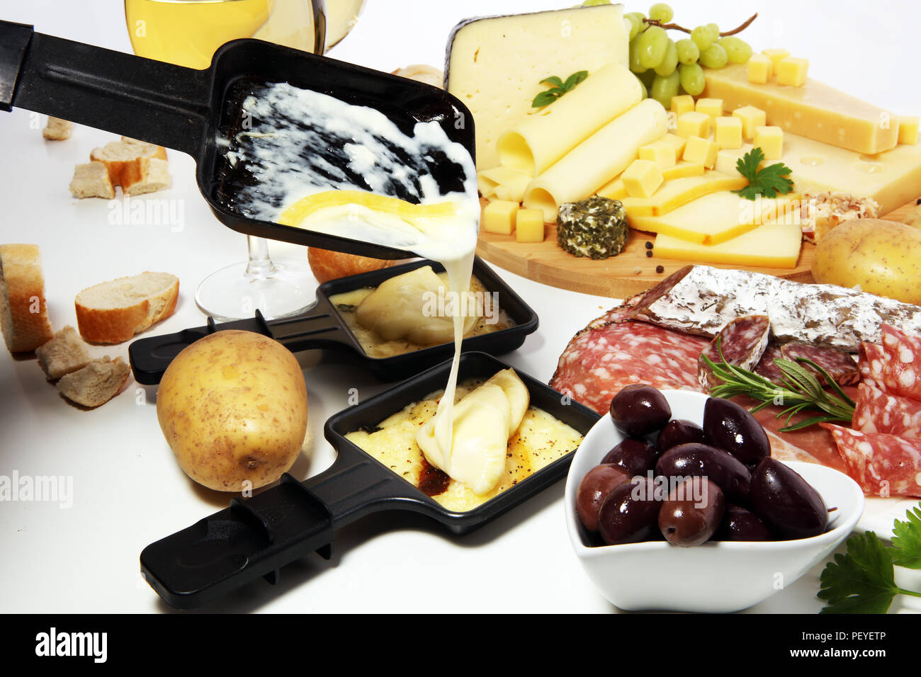 Delicious traditional Swiss melted raclette cheese on diced boiled or ...