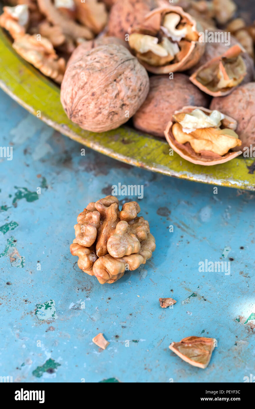 Walnut kernels and whole walnuts on rustic old table Stock Photo - Alamy