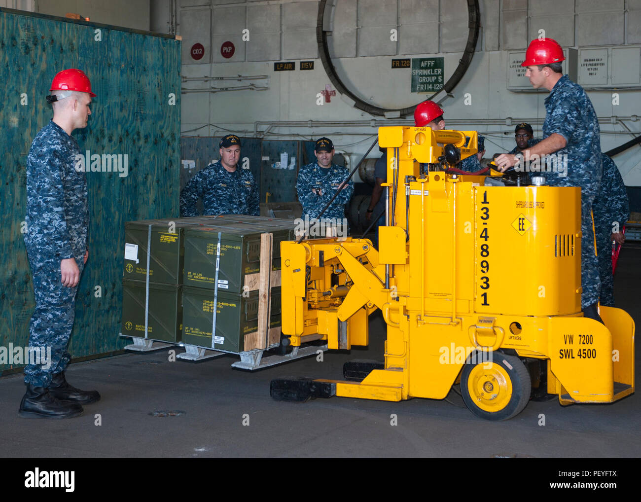 A U.S. Navy Airman operates a forklift aboard aircraft carrier USS Carl ...