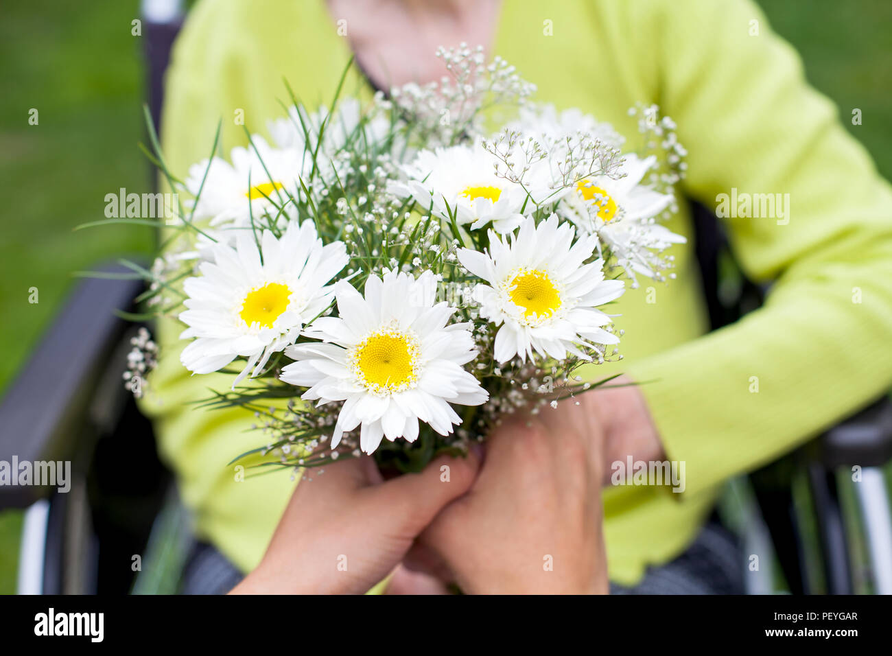 Elderly paralyzed woman receiving a flower bouquet - nursing home ...