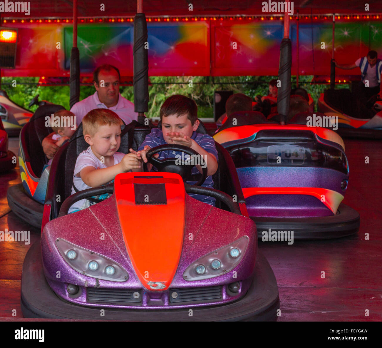 children riding the dodgems or bumper cars on a fairground ride Stock ...