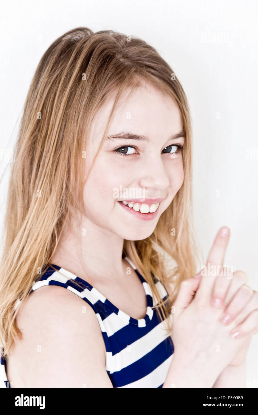 Cute girl eleven years old with blond long hair on white background ...