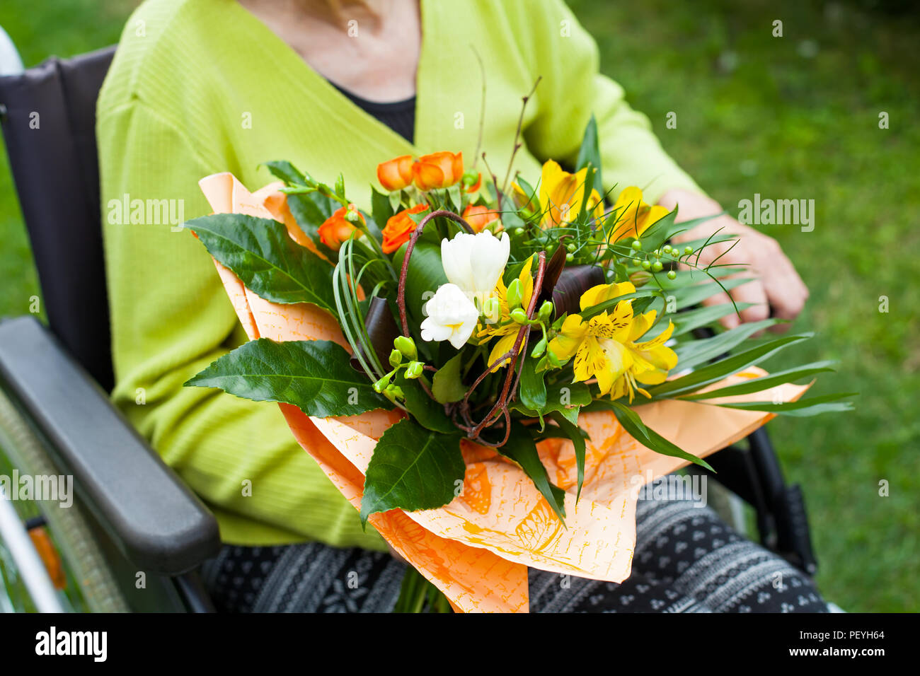 Elderly paralyzed woman receiving a flower bouquet - nursing home ...