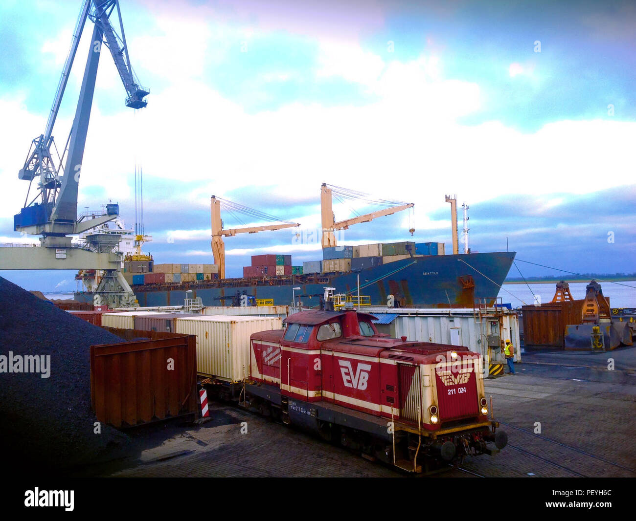 A train moves cargo containers full of ammunition to a railhead where ...