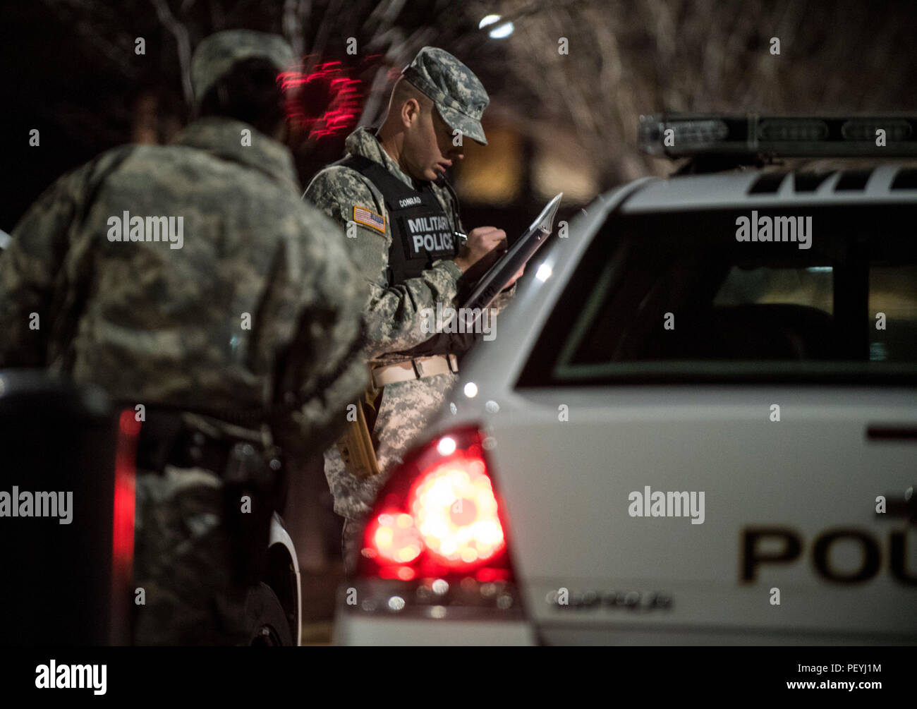 Sgt. Jacob Conrad (right), active duty military police Soldier with the ...