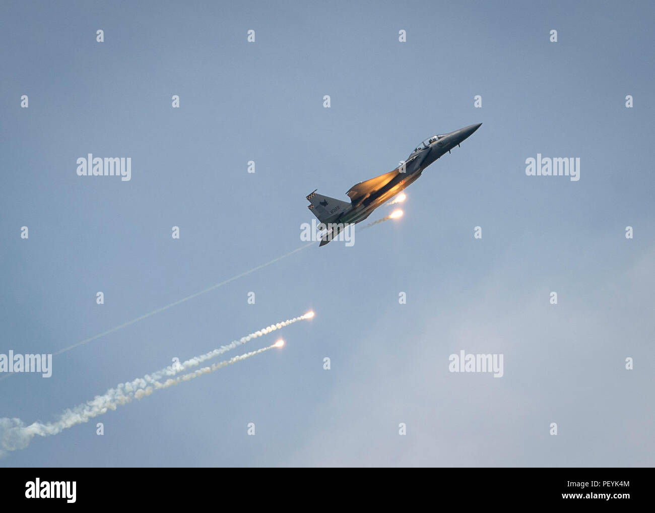 A Republic of Singapore Air Force F-15SG Strike Eagle deploys flares as ...