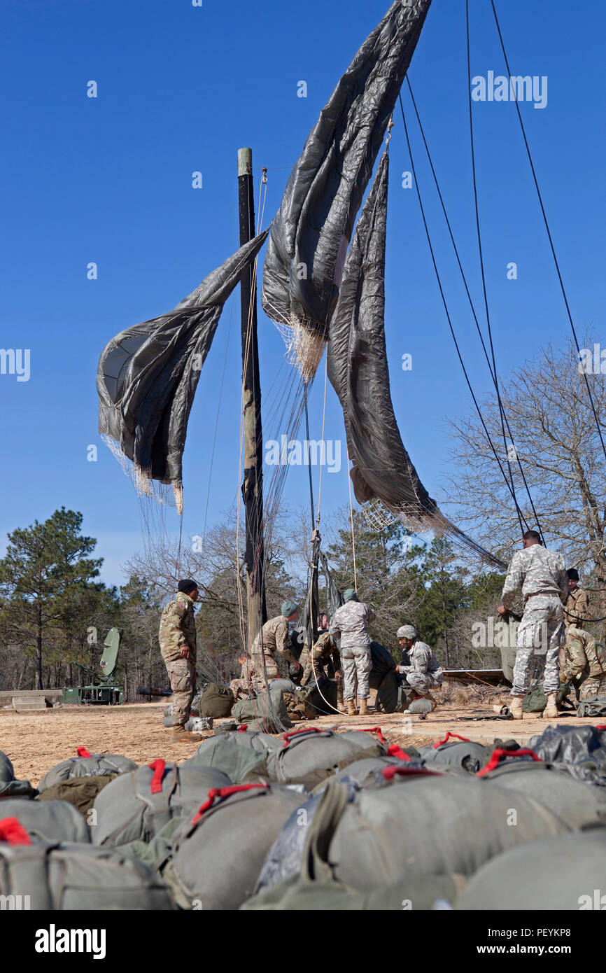 U.S. Army soldiers shake out parachutes following an airborne operation ...
