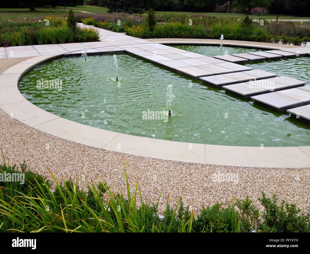 Modern stone slab paving around formal pond hi-res stock photography ...