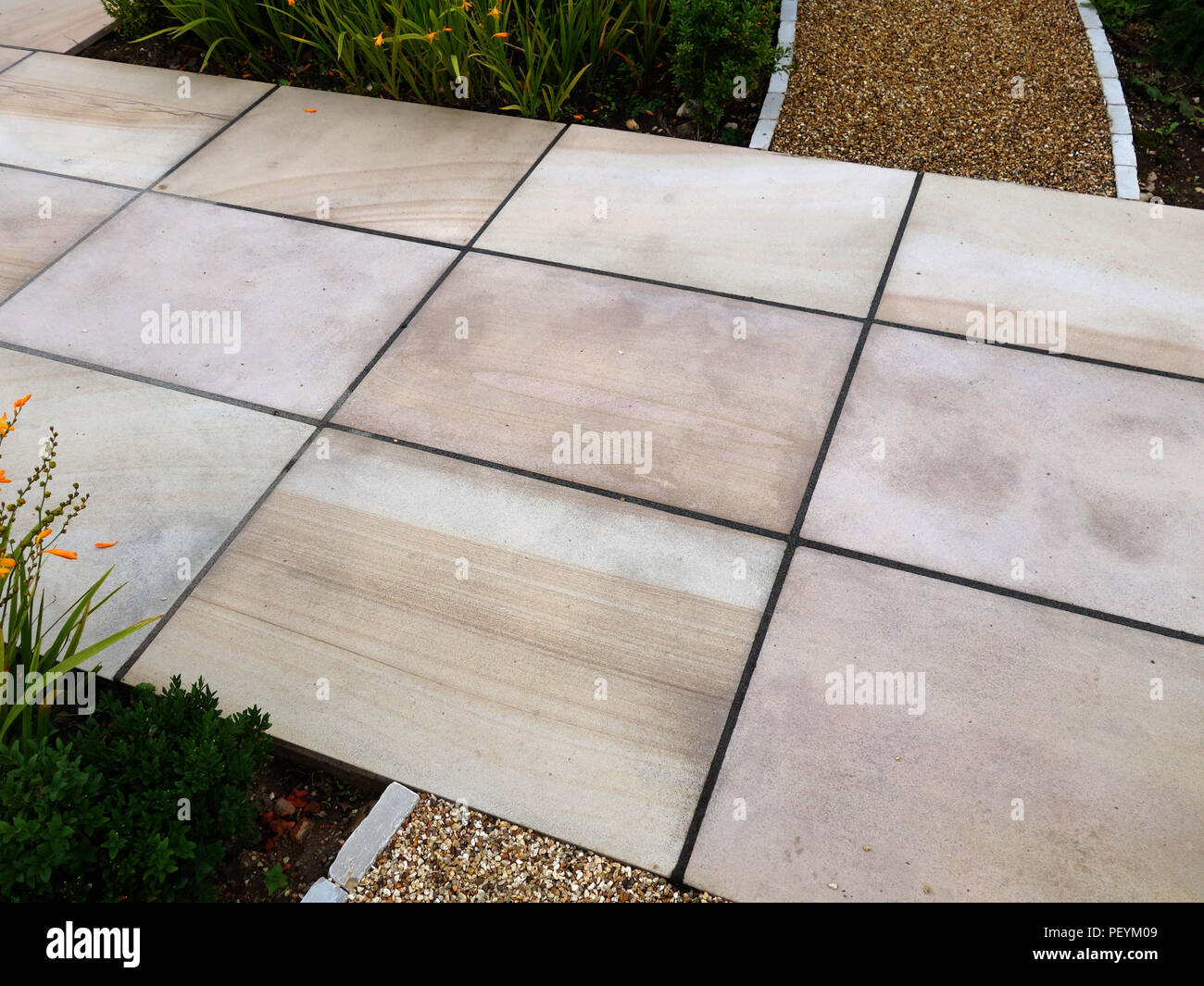 Modern stone slabs forming pathways around a paved area in a formal ...