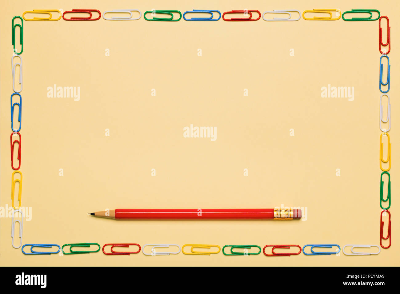 Pencil in a frame of paper clips Stock Photo - Alamy