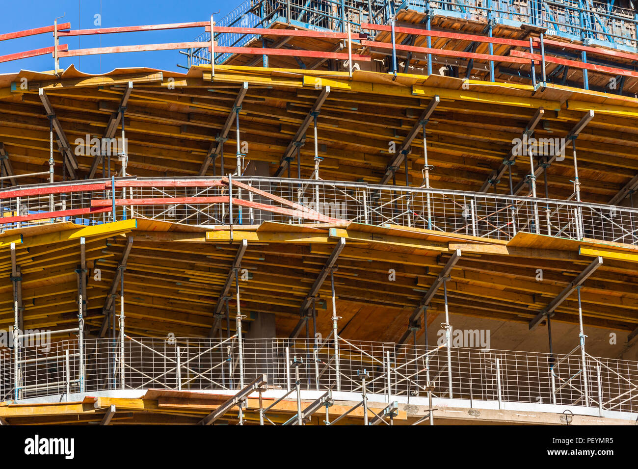 Construction building activity closeup scaffolding floor supports to ...