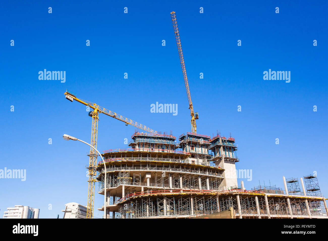 Construction building activity closeup cranes machinery concrete ...