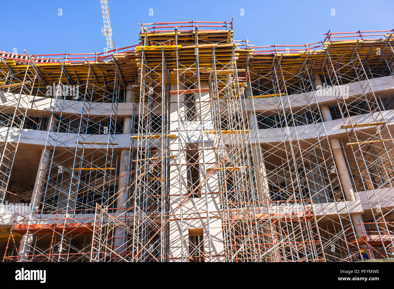 Construction building activity closeup scaffolding floor supports to ...