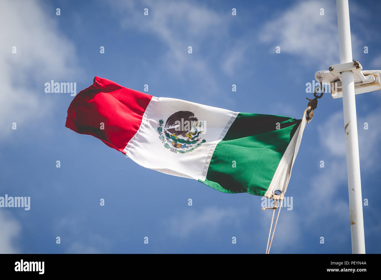 Mexican flag flying on the top of a ship on a sunny day Stock Photo - Alamy
