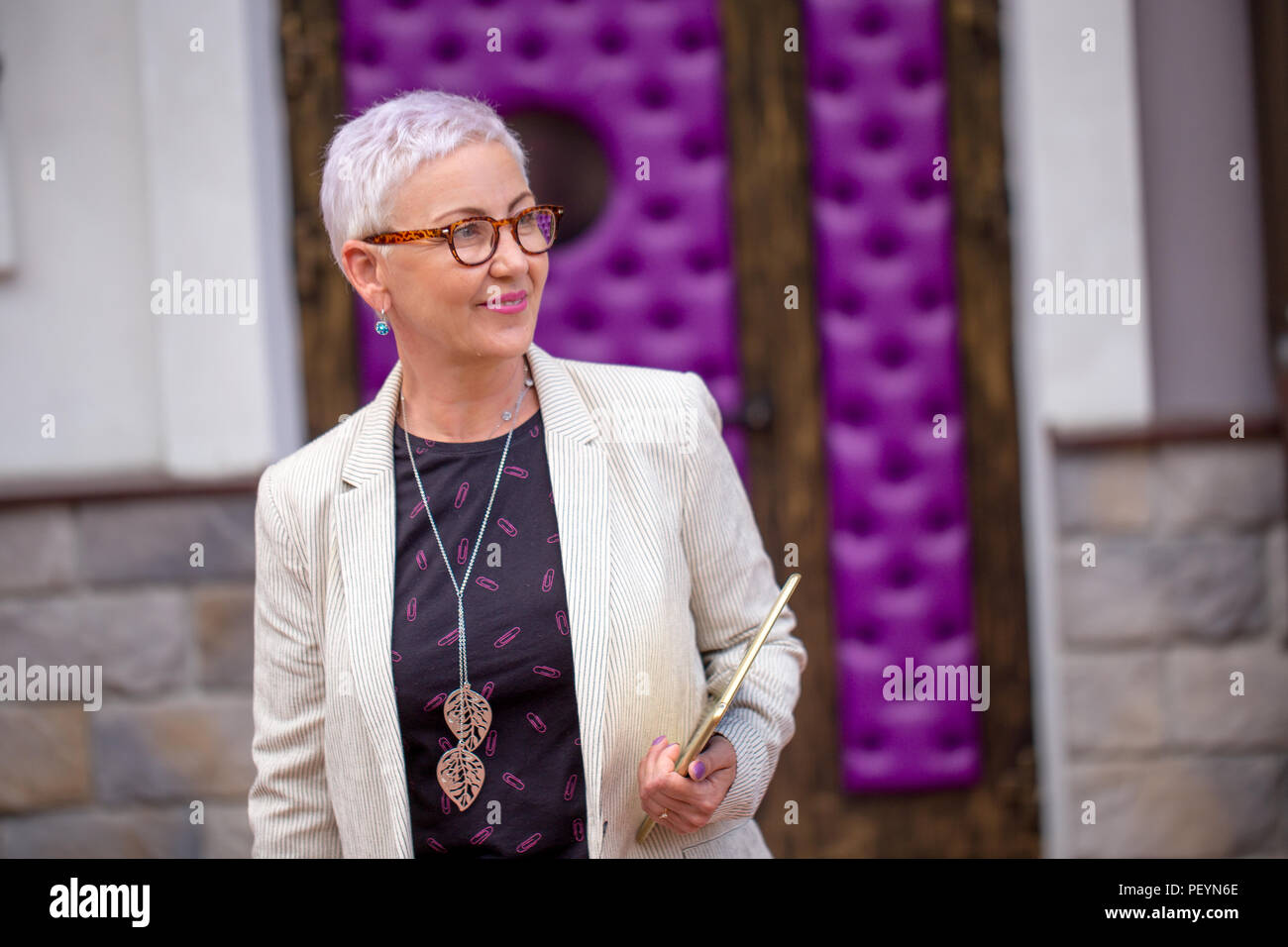side view photo of beautiful female professor with tablet standing on ...