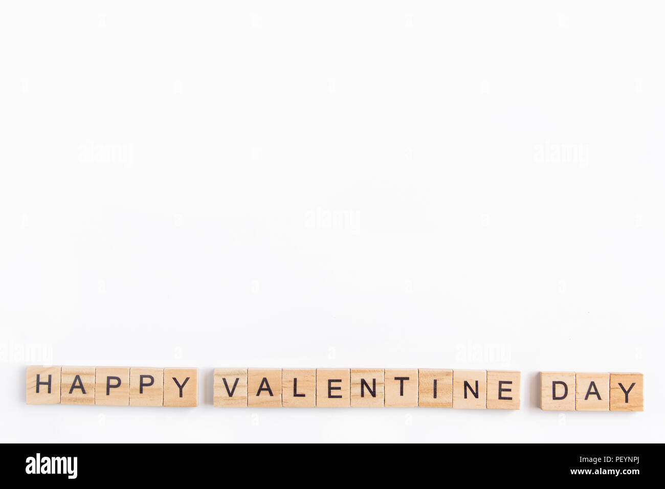 Alphabet letter wooden blocks tiles Valentine`s day on white background ...
