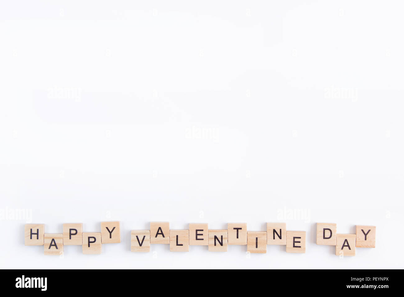Alphabet letter wooden blocks tiles Valentine`s day on white background ...