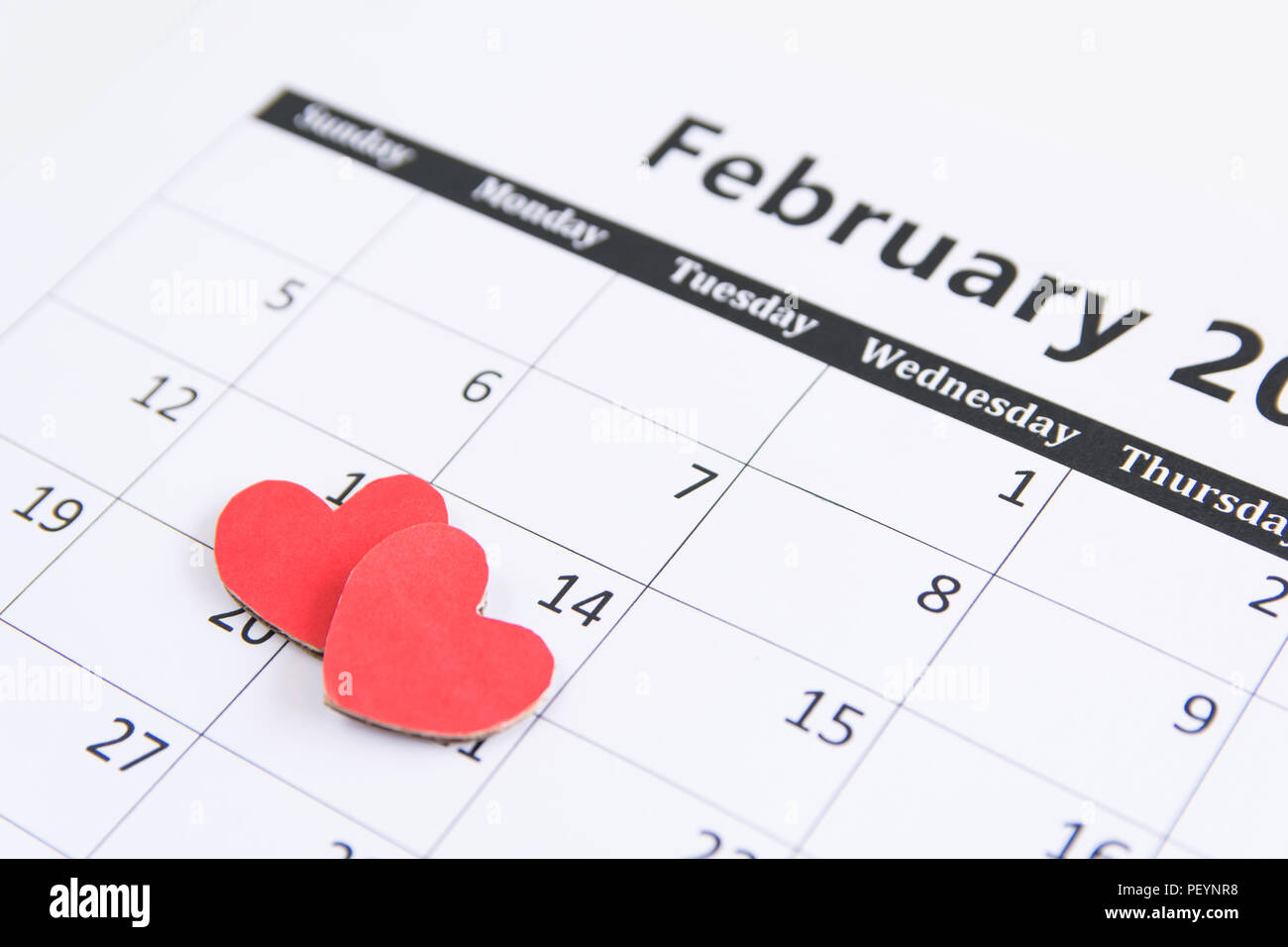Calendar page and red hearts paper on February 14 of Valentines day ...