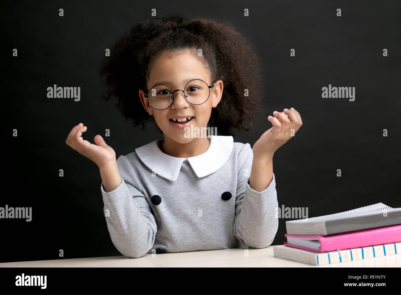 cheerful pretty girl is answering to the teacher's question. girl is ...