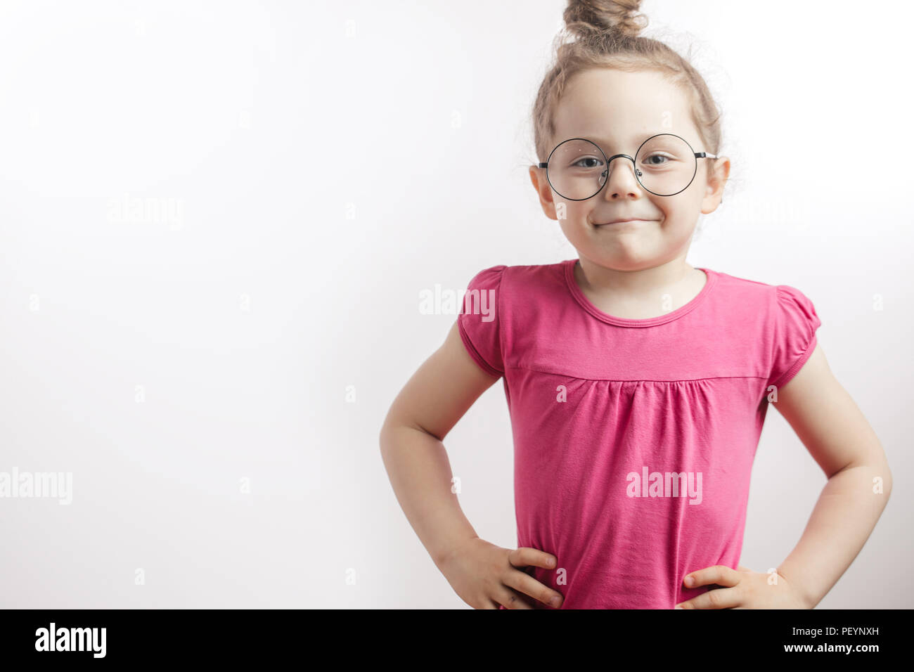Cute ginger good looking little girl standing with hands on hips.copy ...
