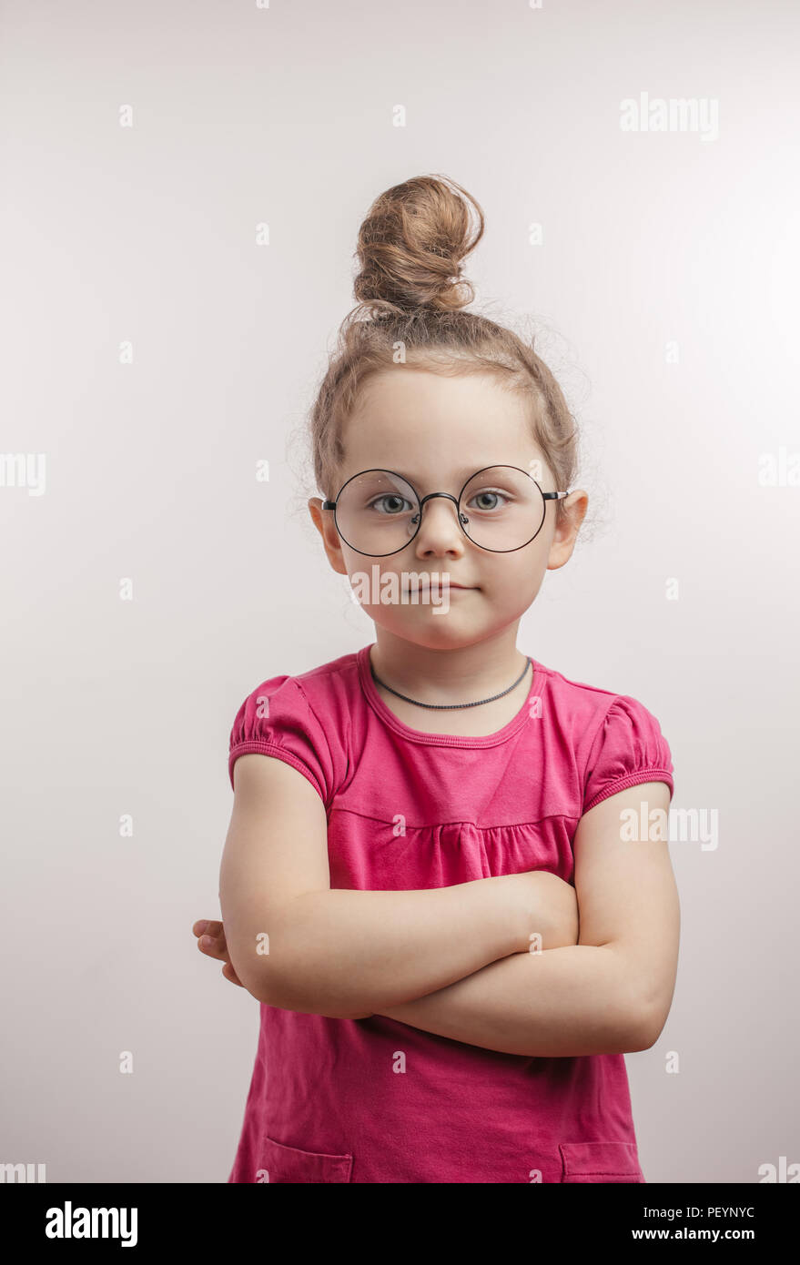 confident ginger kid wearing round eyeglasses standing with folded arms ...