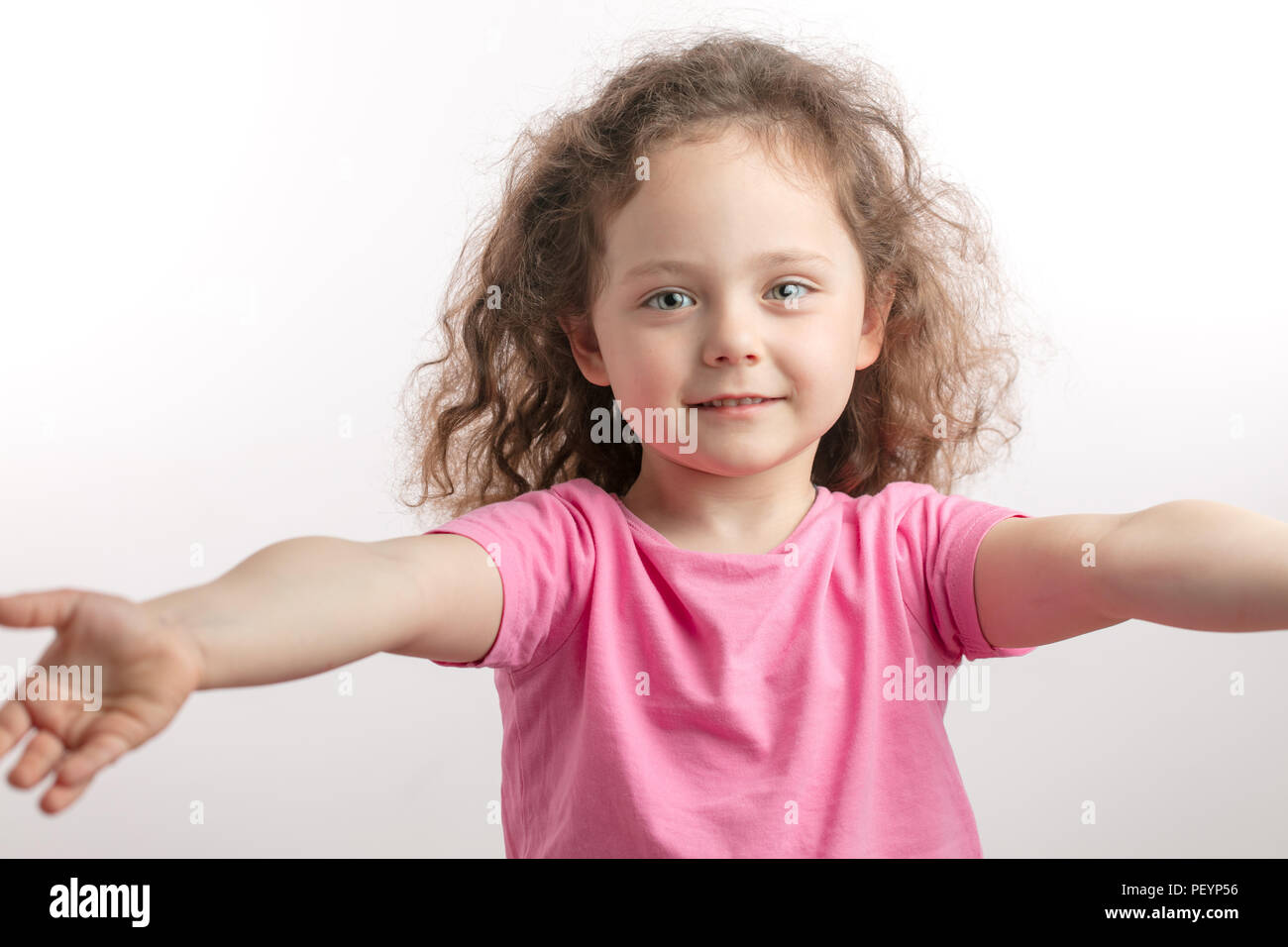 kind, friendly girl is welcoming guests. kid is going to hug somebody ...