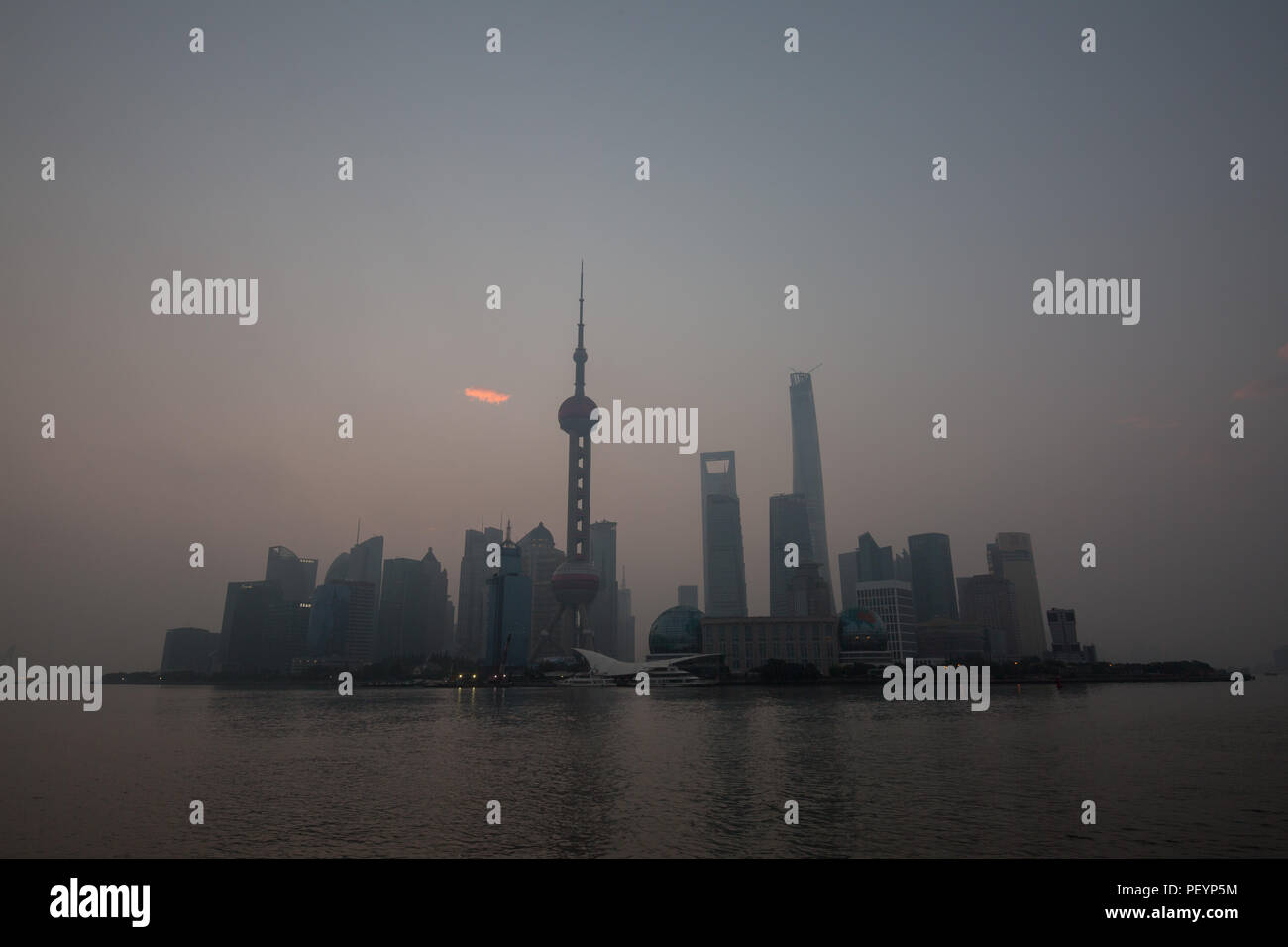 a big asia city by night to the sunrise with all the lights on the ...