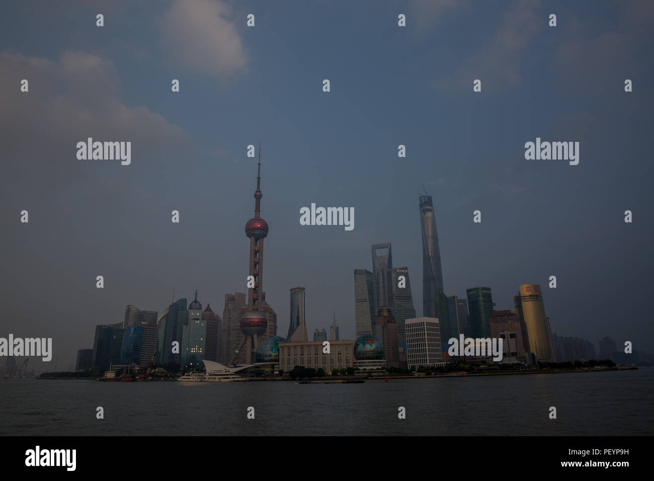 a city in asia with traffic and a river between skyscrapers Stock Photo ...