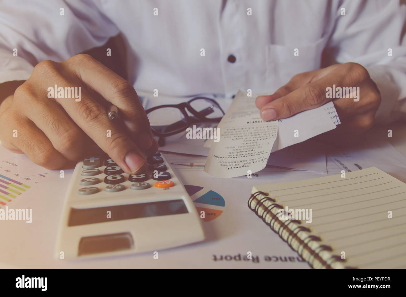 Man hand using calculator with calculate bills and Financial data ...