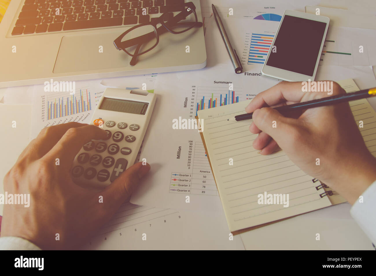 Man hand using a financial calculator with writing make note and ...