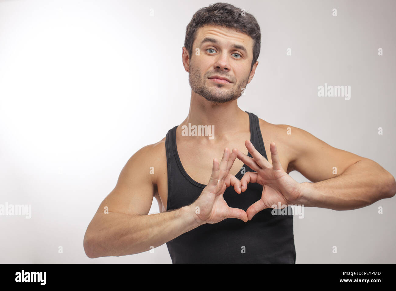 sentimental man with heart sign. handsome man showing his love to a ...